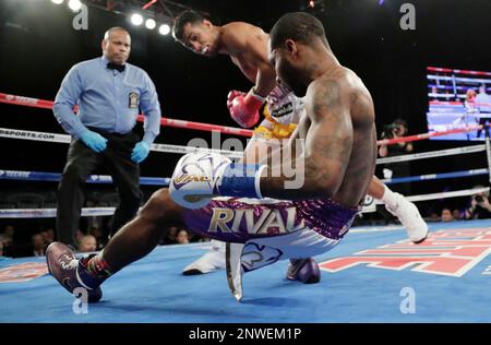 Puerto Rico's Alberto Machado, left, knocks down Yuandale Evans during ...