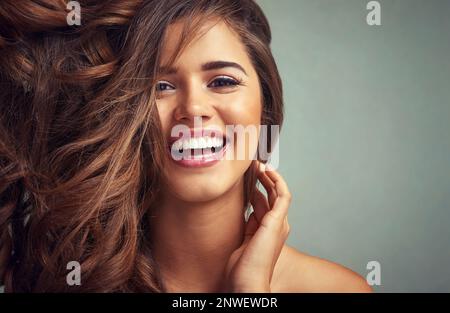 Lucious locks. Studio portrait of a beautiful woman with long locks ...