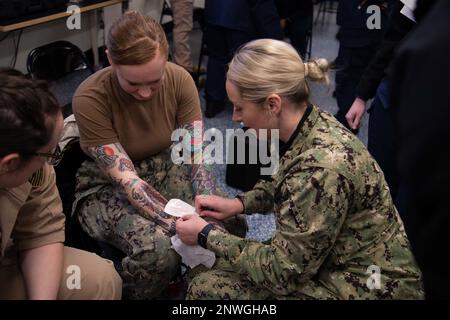 US Navy Hospital Corpsman Susan Piche administers the first in a series ...