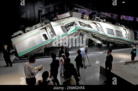Damaged Joban Line train (L) and Shinkansen bullet train are placed at ...