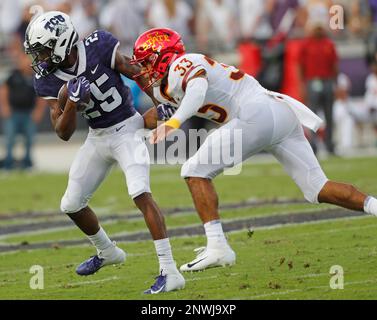 TCU wide receiver KaVontae Turpin (25) fights off a tackle attempt by ...