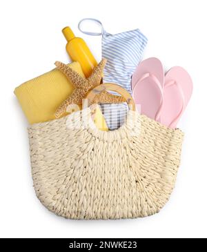 Knitted bag with beach accessories on light blue background Stock Photo ...