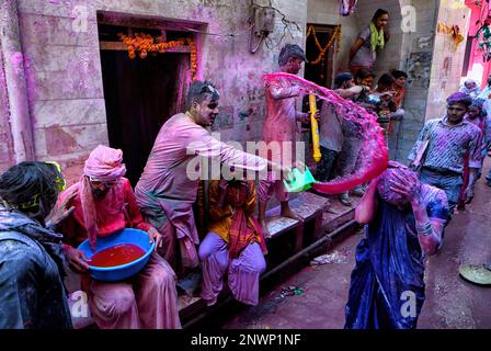 A youth of Barasana welcomes devotees with colorful powders (gulal) and ...