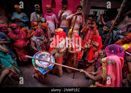 Hindu men are being ritually beaten with sticks (Lathi) during the ...