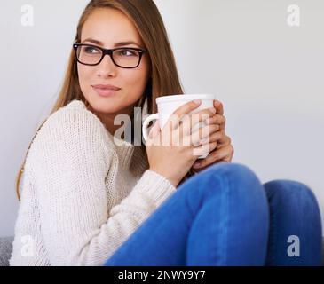 Attractive young brunette woman having a healthy breakfast reading a ...