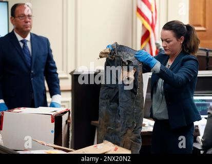 Larry Peterson, left, GBI forensic investigator, watches as Marie ...