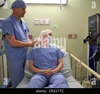 A Certified Registered Nurse Anesthetist (CRNA) inserting a ...