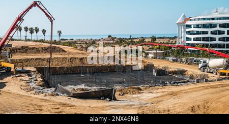 Concrete pump working on reinforced foundations at a large construction ...