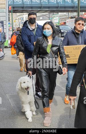 An Asian woman in a leather coat and jeans walking around Europe city ...