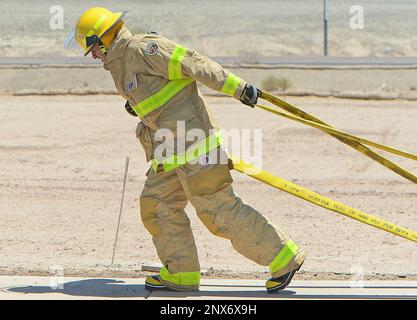 firefighter during the drill with hose hydrant Stock Photo - Alamy