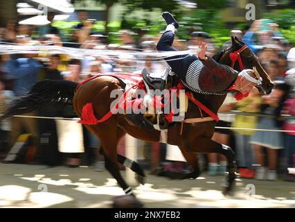 A man performs on a horse running in full speed during Kakeuma Shinji ...