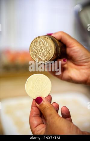 The making of traditional "Corzetti", a pasta typical from the Italian ...