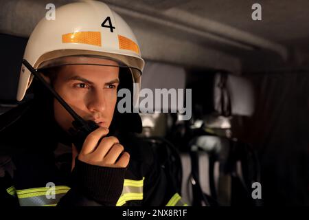 Firefighter using portable radio set in fire truck Stock Photo - Alamy