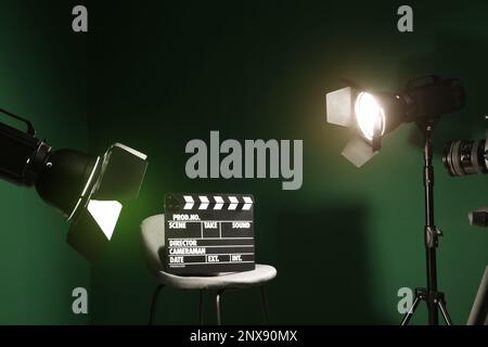 Chair with clapperboard under spotlight in studio Stock Photo - Alamy