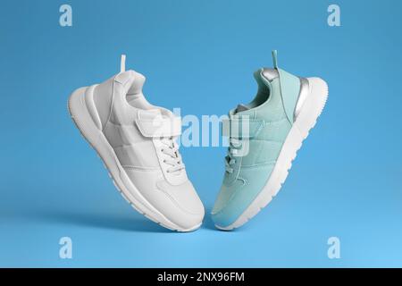 Two stylish sneakers on light blue background. Space for text Stock ...