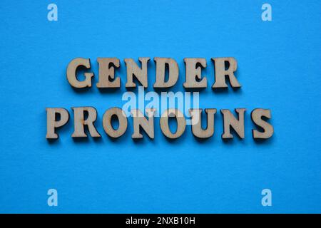 Gender Pronouns, words in wooden alphabet letters isolated on pink ...