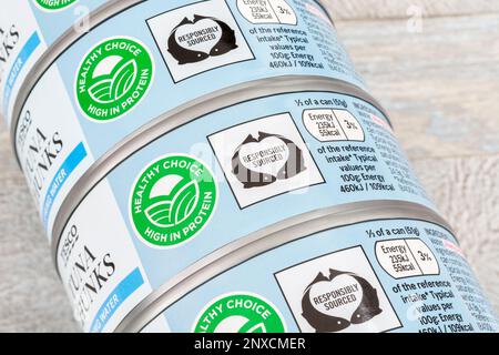 Cans of tinned Tesco Tuna chunks on a kitchen table. For UK food ...