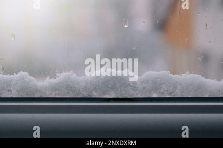Frosted window with snow outside with sunrise background Stock Photo ...