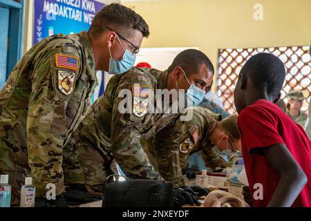 A Kenyan Defence Forces army medic adjusts a tourniquet during tactical ...