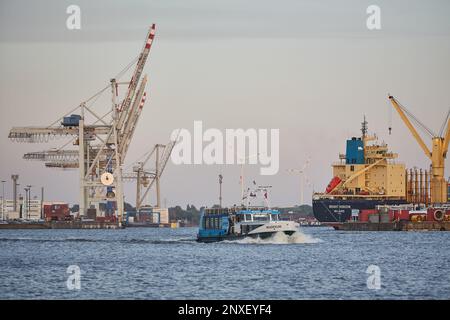 upstream view of river Elbe with container terminals, cranes, oil tanks ...