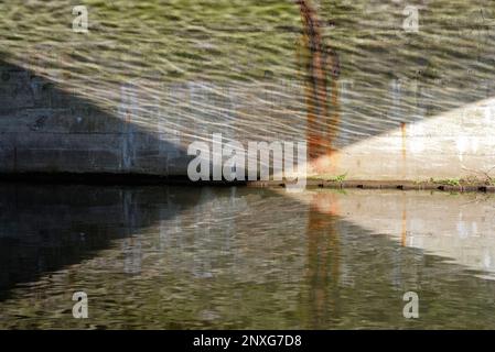 Abstract triangular shapes formed by reflections onto water surface and ...