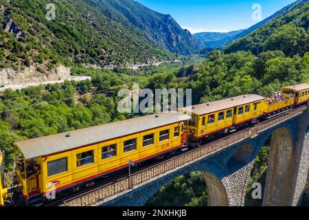 Aerial view of The Yellow Train or Train Jaune on Sejourne bridge ...