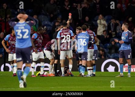 Fleetwood Town's Cian Hayes (centre) is shown a red card by referee ...
