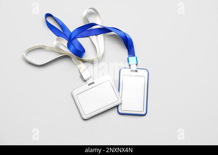 Blank badges on light blue background, flat lay. Mockup for design ...