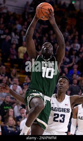 Utah State forward Daron Henson (23) shoots as New Mexico guard Makuach ...