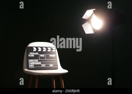 Chair with clapperboard under spotlight in studio Stock Photo - Alamy