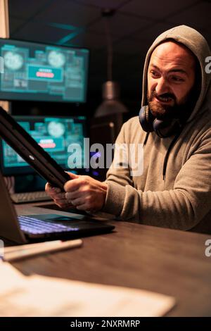 Displeased angry hacker throwing keyboard in office, feeling mad about ...