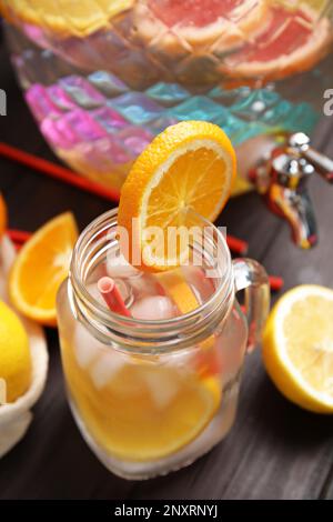 Refreshing drink dispenser with glass jar container full of yellow ...