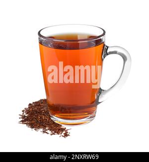 Aromatic rooibos tea in glass cup and scattered dry leaves on white ...