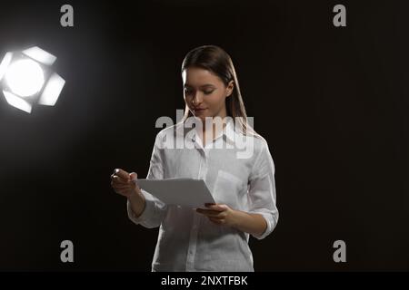Professional actress reading her script during rehearsal in theatre ...