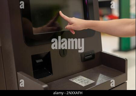 Faceless woman using touchscreen ATM Stock Photo - Alamy