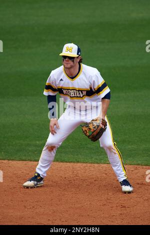 Michigan Wolverines shortstop Michael Brdar (9) follows through on his ...