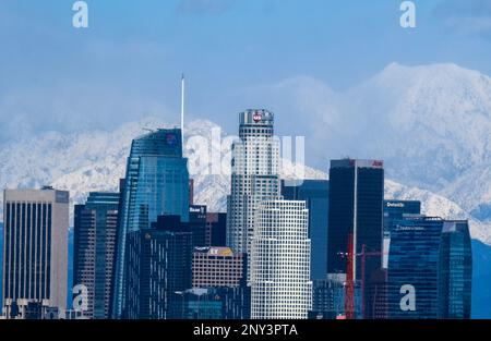 Skyline of Los Angeles after a winter storm featuring snow on mountains ...