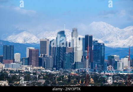 Skyline of Los Angeles after a winter storm featuring snow on mountains ...