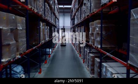Interior of warehouse store with parcels and shelf unit Stock Photo - Alamy