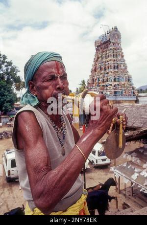 Sadhu blowing conch standing infornt of Nataraja temple in Perur near ...