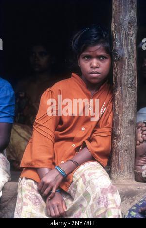A group of Betta Kurumba, hill tribes of Nilgiris sitting the hut at ...