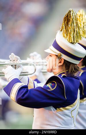 A member of the University of Washington Husky Marching Band offers a ...