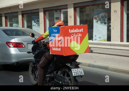 Delivery boy Talabat food Delivery rider on road. Doha Roads and ...