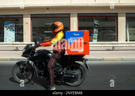 Delivery boy Talabat food Delivery rider on Doha road Stock Photo - Alamy