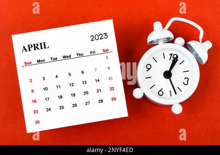 April 2023 Monthly calendar for 2023 year with alarm clock on yellow ...