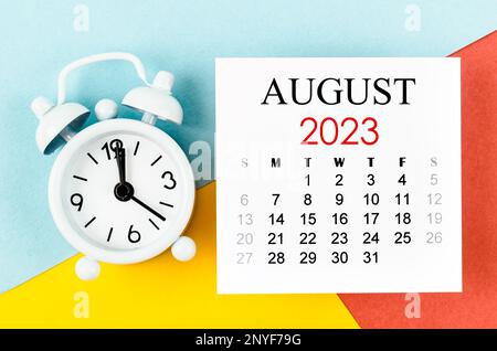 August 2023 Monthly calendar for 2023 year with alarm clock on yellow ...