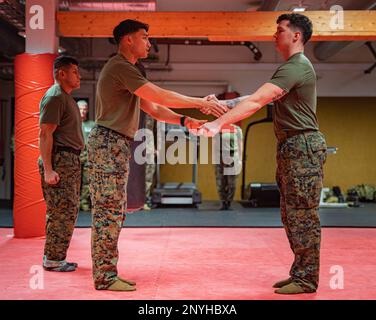 A Marine Corps company commander presents a Certificate of Commendation ...