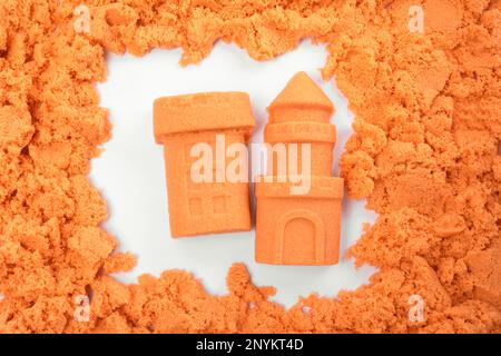Castle and tower made of kinetic sand on white background, top view ...