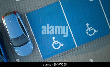 Handicapped parking space aerial view with yellow lines and asphalt ...