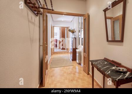 Entrance hall of a house with an L-shaped corridor with door carpentry ...